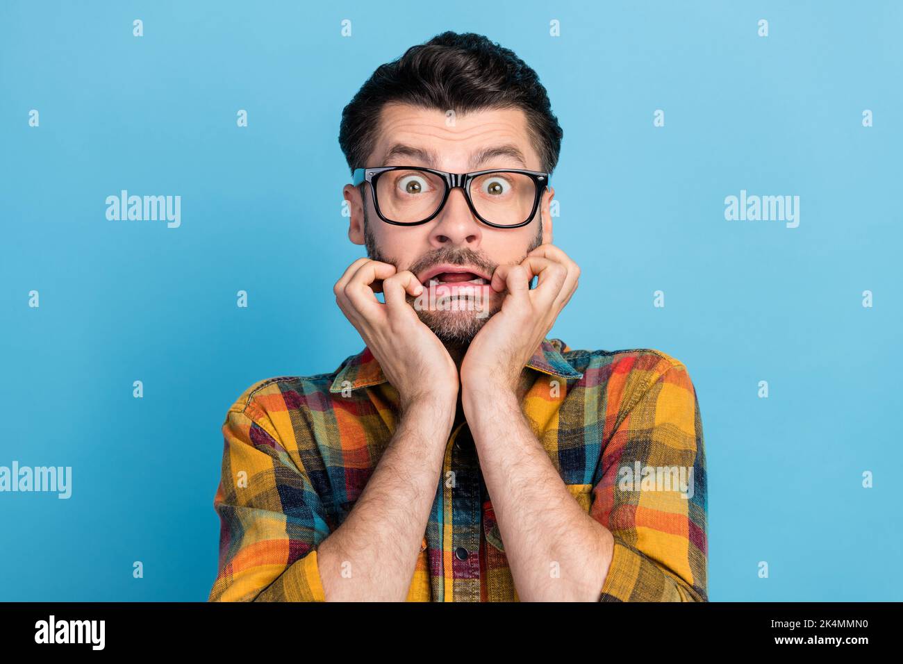 Photo of impressed handsome terrified guy dressed eyeglasses checkered shirt staring at camera ...