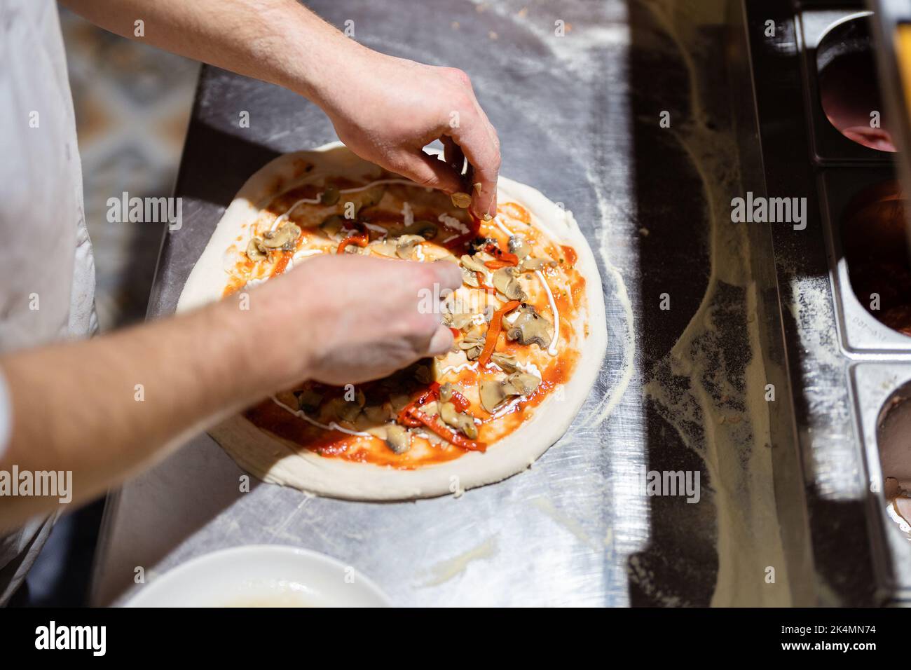 Pizza making process. Male chef hands making authentic pizza in the ...