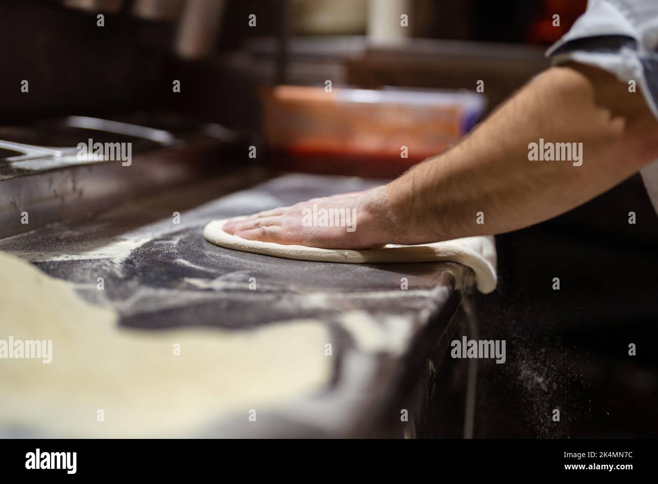 Pizza making process. Male chef hands making authentic pizza in the ...