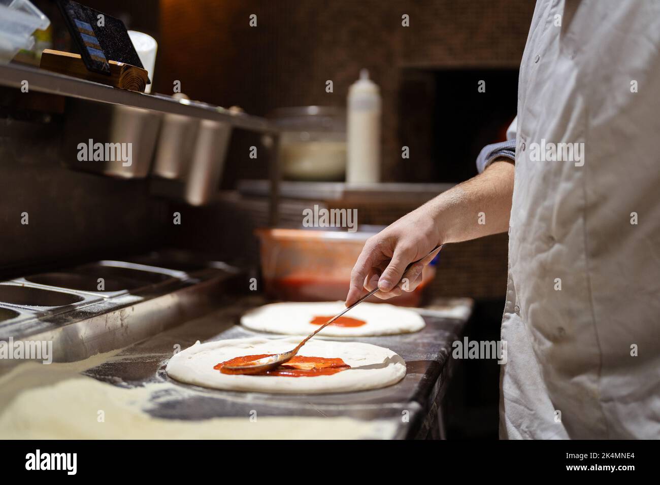 Pizza making process. Male chef hands making authentic pizza in the ...