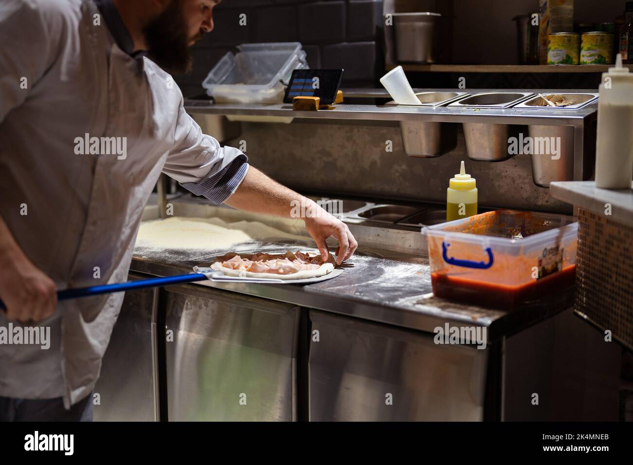 Pizza making process. Male chef hands making authentic pizza in the ...