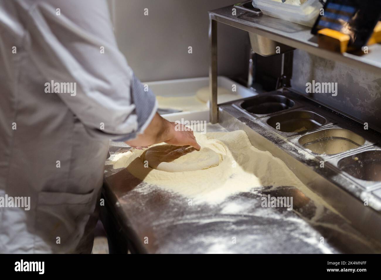 Pizza making process. Male chef hands making authentic pizza in the ...