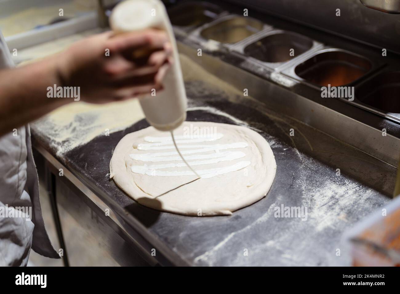 Pizza making process. Male chef hands making authentic pizza in the ...