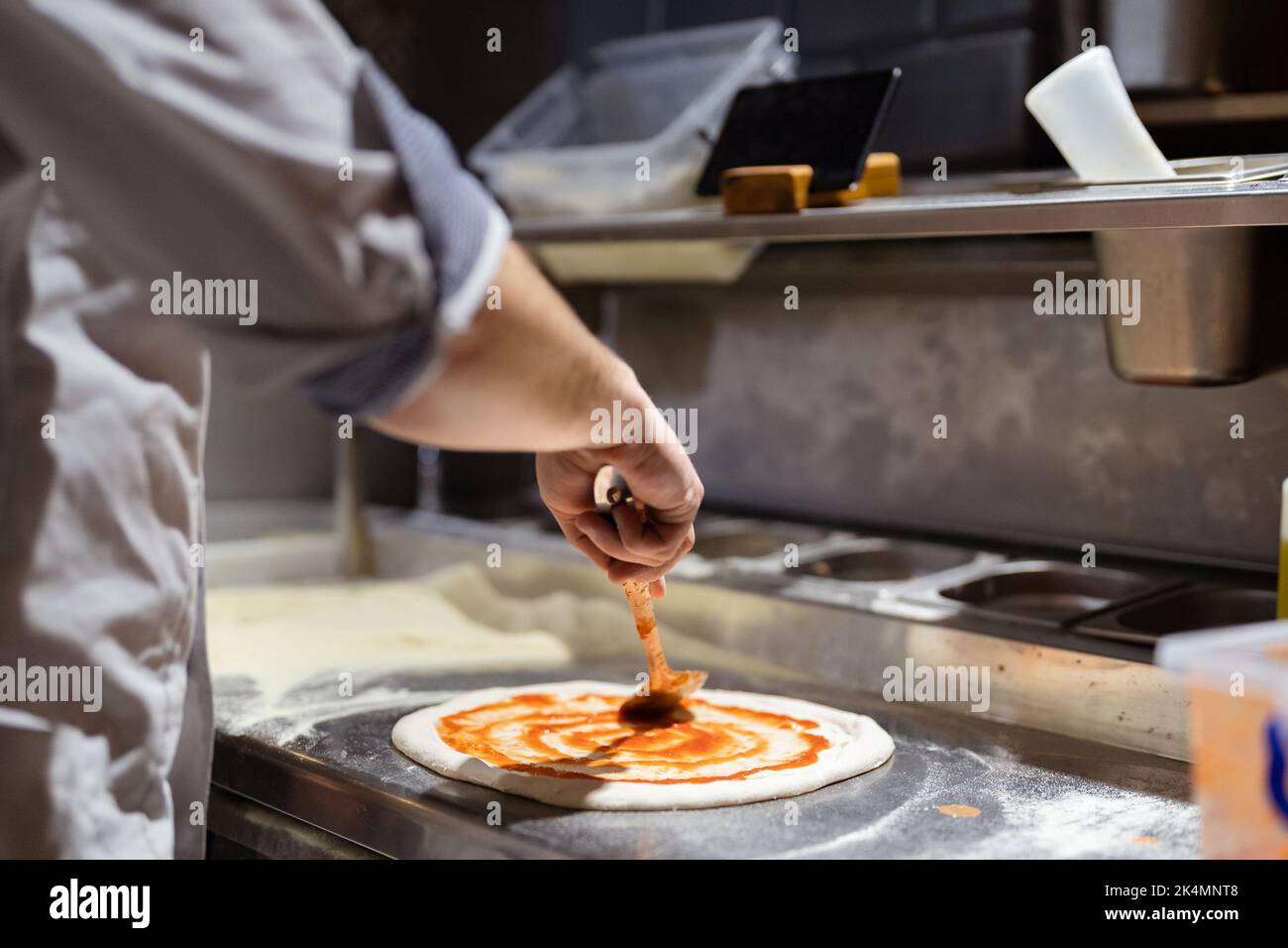 Pizza making process. Male chef hands making authentic pizza in the ...
