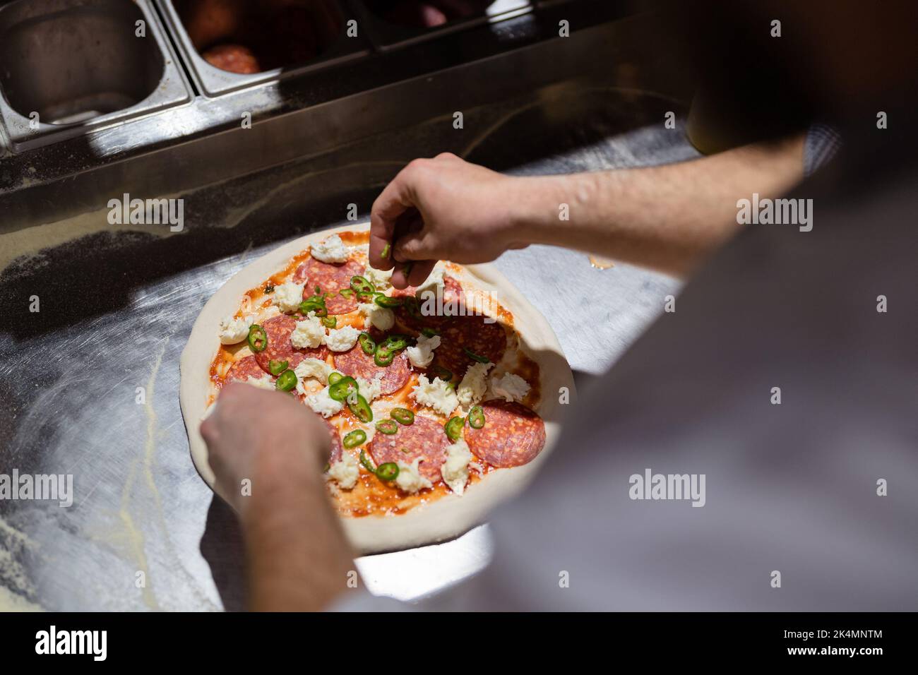 Pizza making process. Male chef hands making authentic pizza in the ...