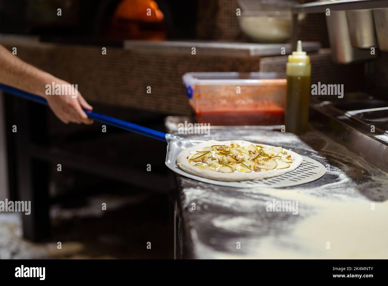 Pizza making process. Male chef hands making authentic pizza in the ...