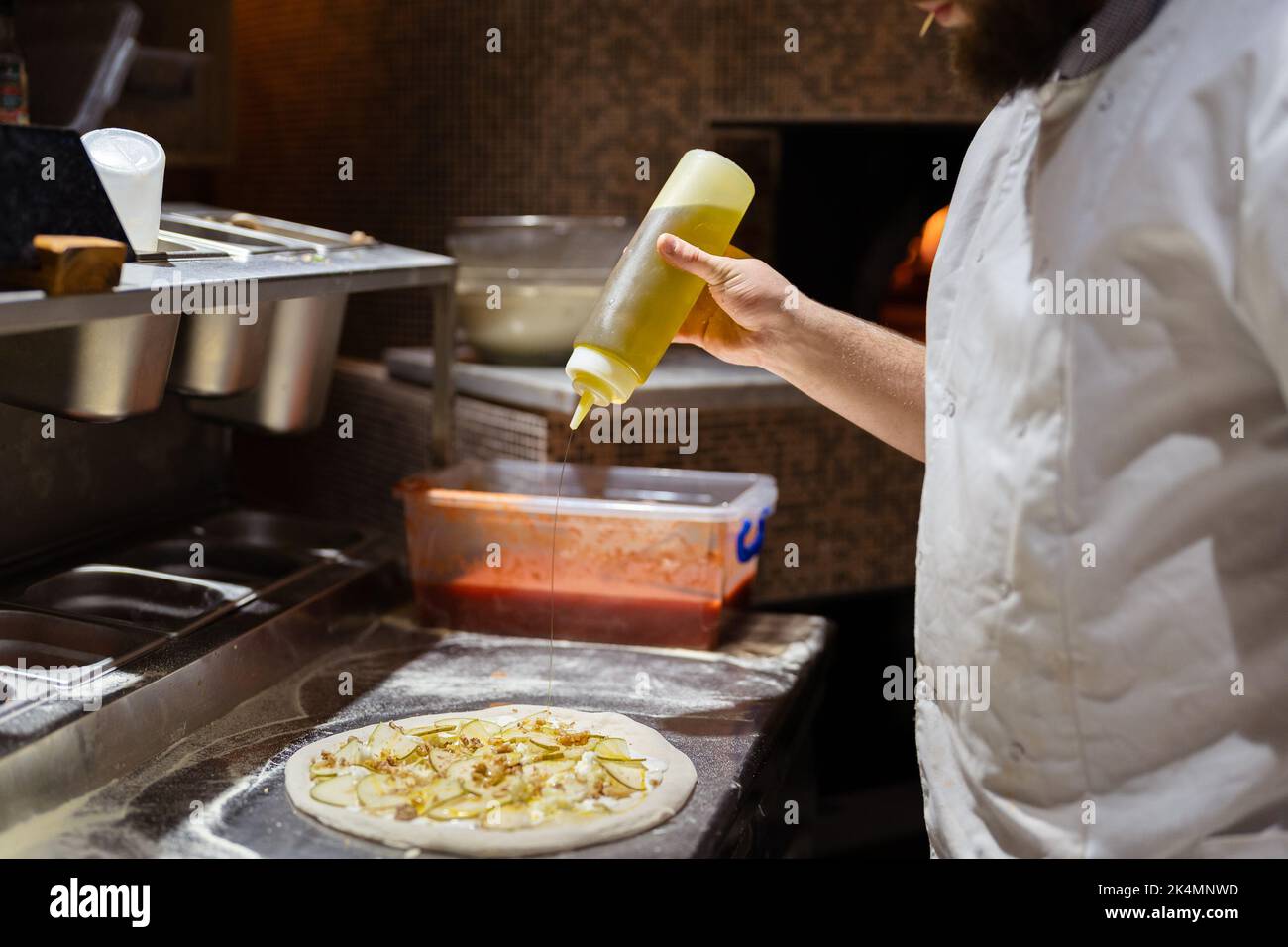 Pizza making process. Male chef hands making authentic pizza in the ...