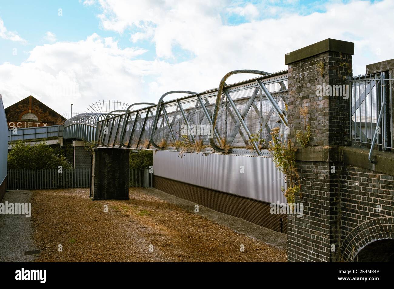 old iron and brick footbridge over railway lines Eccles Manchester UK ...