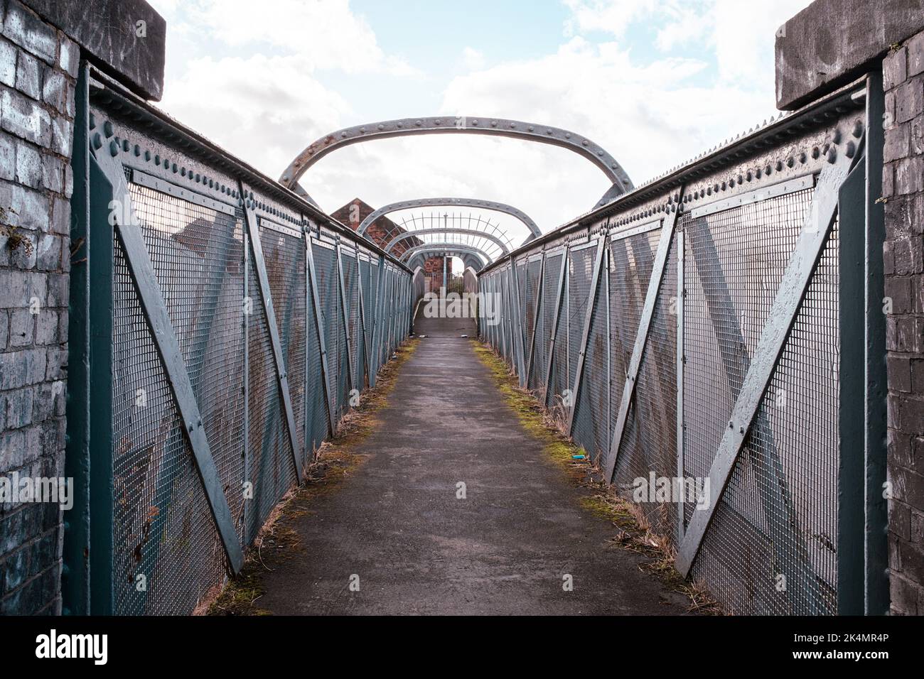 old iron and brick footbridge walkway over railway lines Eccles ...