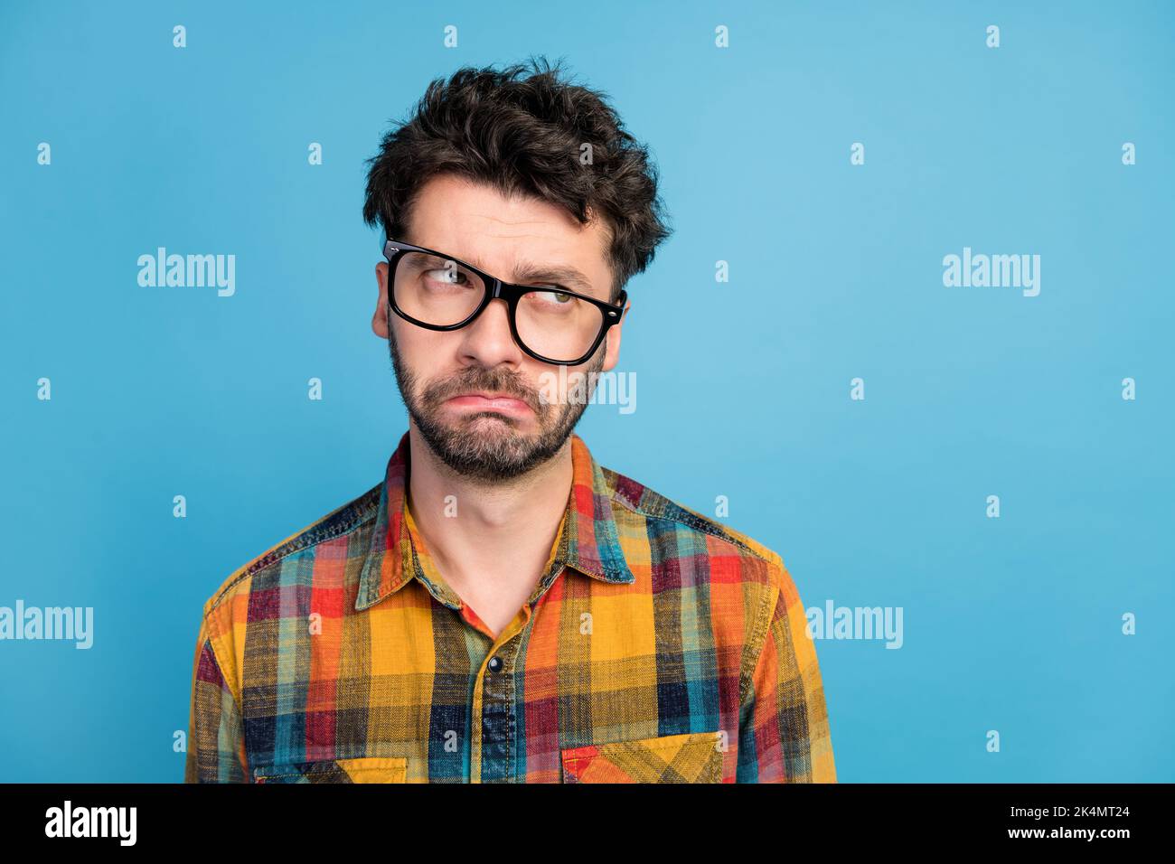 Photo of sad brunet guy look promo wear eyewear plaid shirt isolated on ...