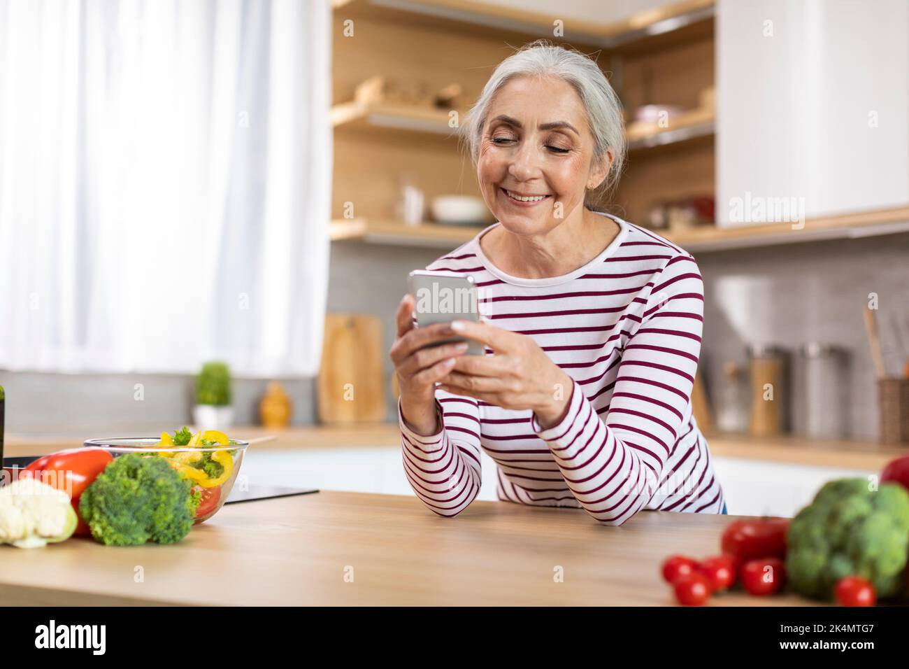 Mobile Communication. Portrait Of Smiling Senior Lady Using Smartphone ...