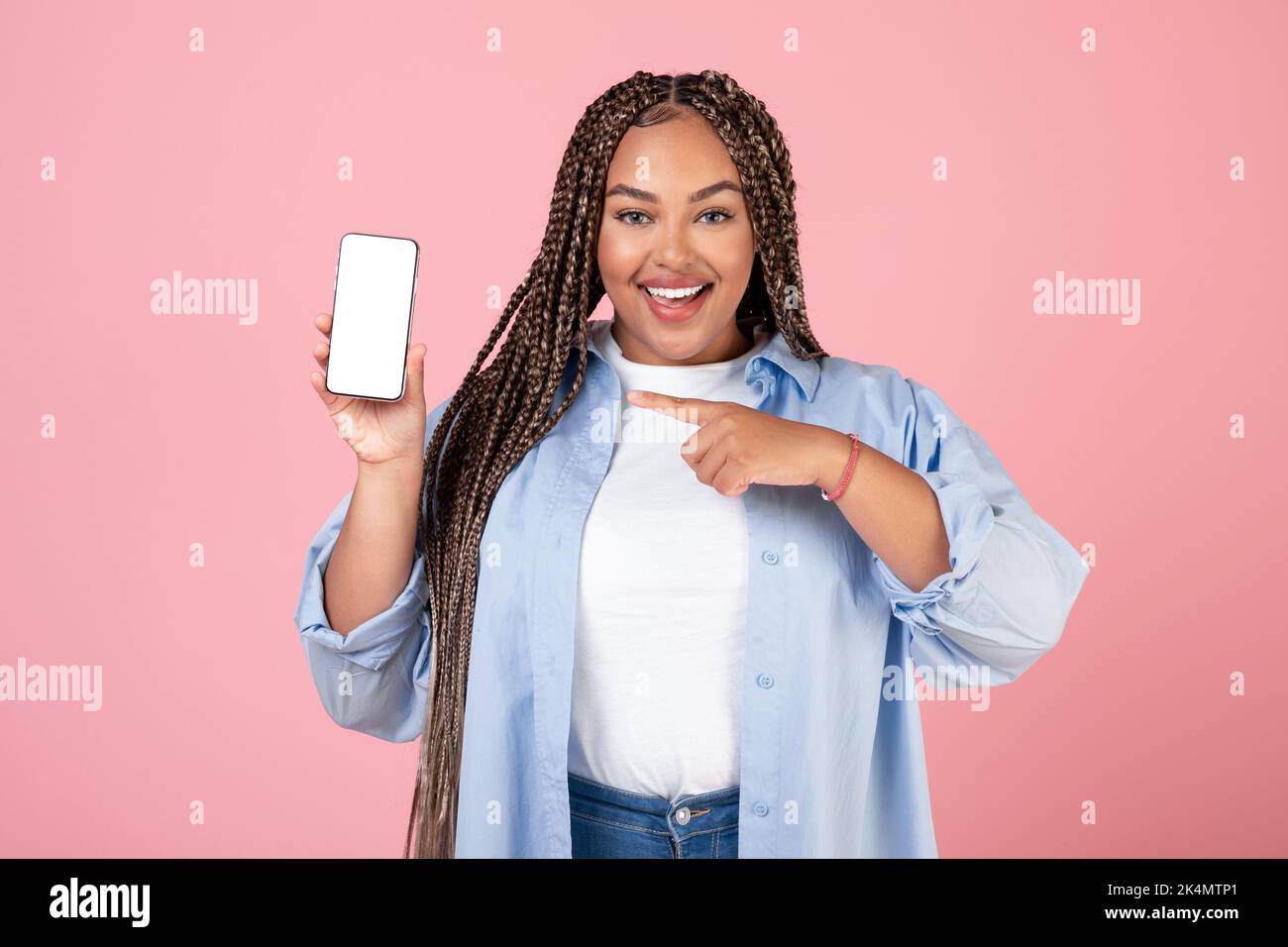 African American Lady Holding Smartphone Pointing At Screen, Pink ...