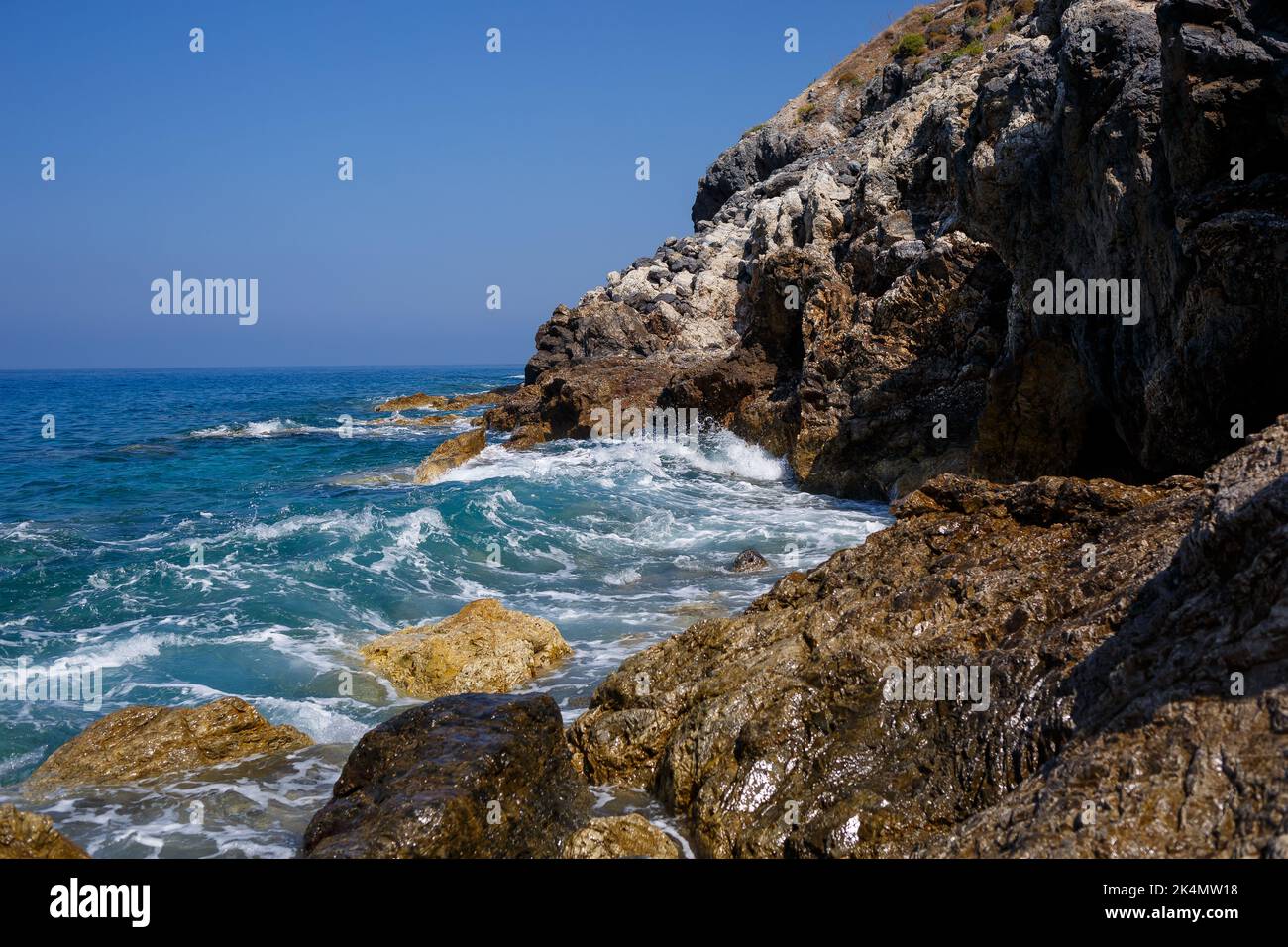 Wonderful views of the blue Mediterranean Sea. Sunny rocks, waves with ...