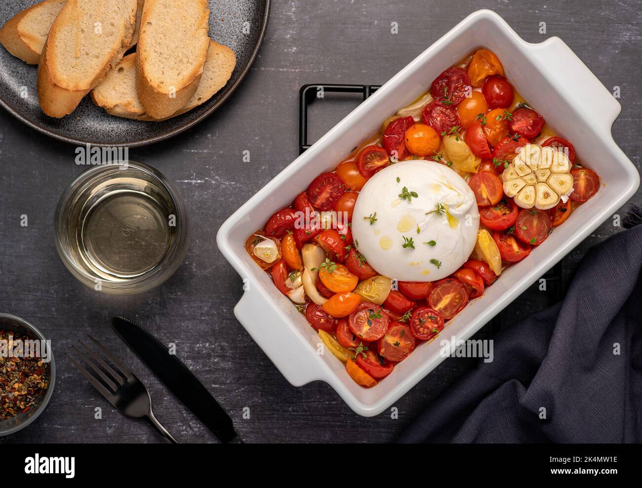 Food photography of burrata with baked tomatos, garlic, thyme, toast ...