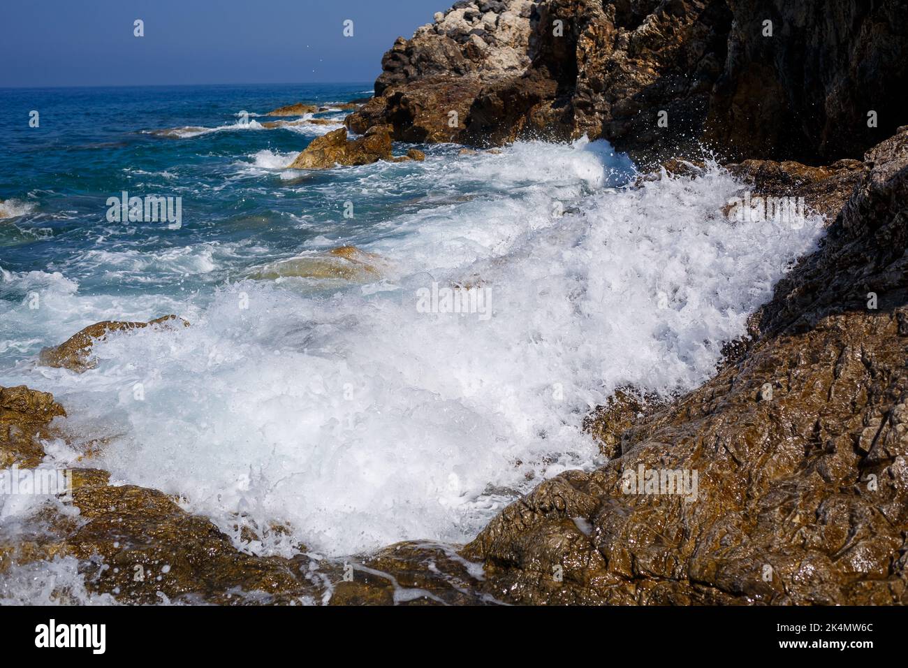 Wonderful views of the blue Mediterranean Sea. Sunny rocks, waves with ...