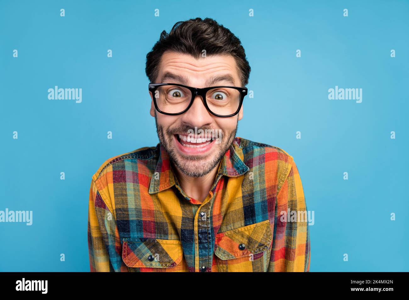 Photo of crazy speechless impressed guy in spectacles dressed checkered ...
