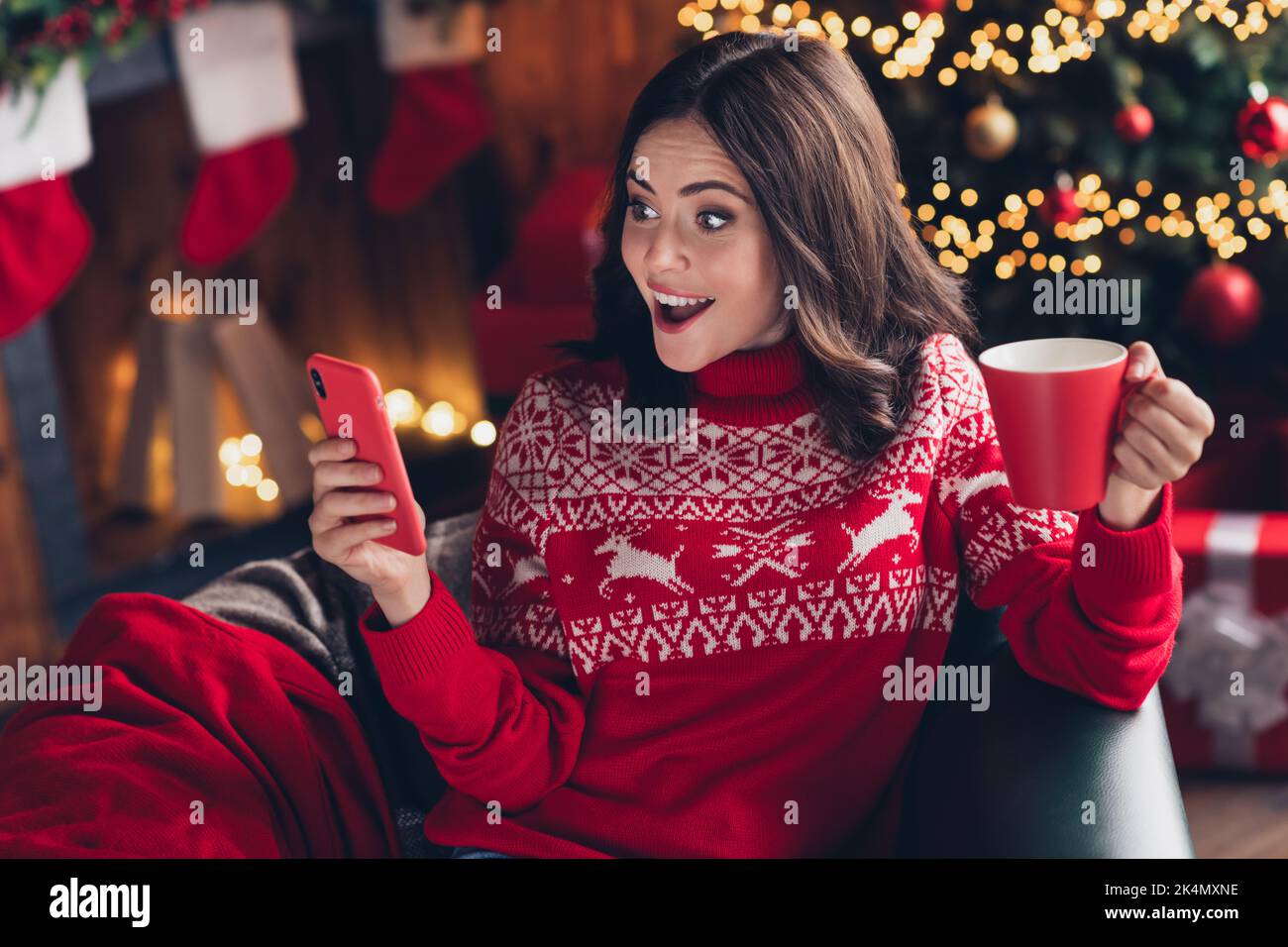 Photo of excited funny girl sit chair hold mug use telephone unexpected ...