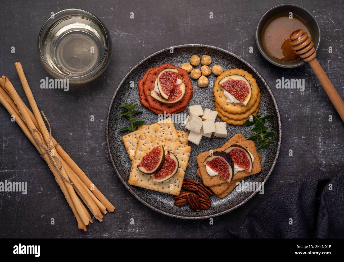 Food photography of wine, soft cheese, salami, figs, crackers, feta ...
