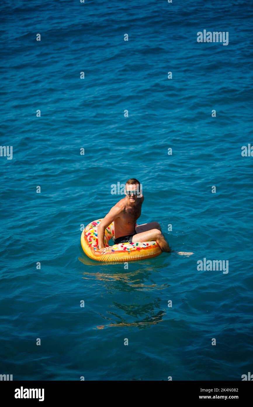 Fat man float pool hi-res stock photography and images - Alamy