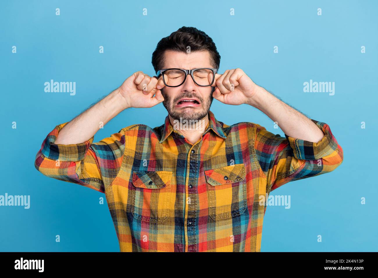 Photo of sad brunet guy crying wear spectacles checkered shirt isolated ...