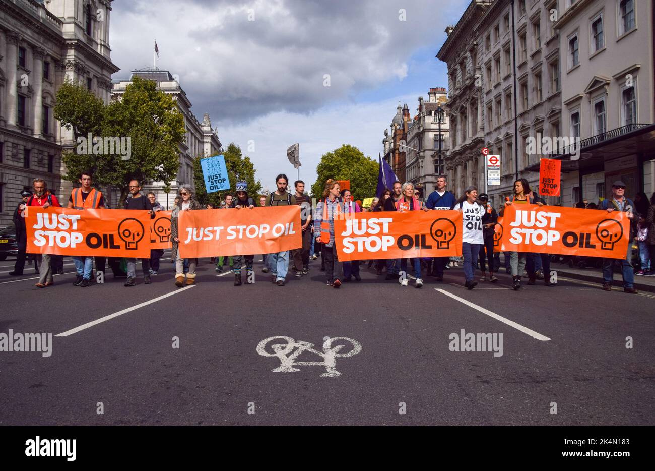London, UK. 03rd Oct, 2022. Protesters march with Just Stop Oil banners ...