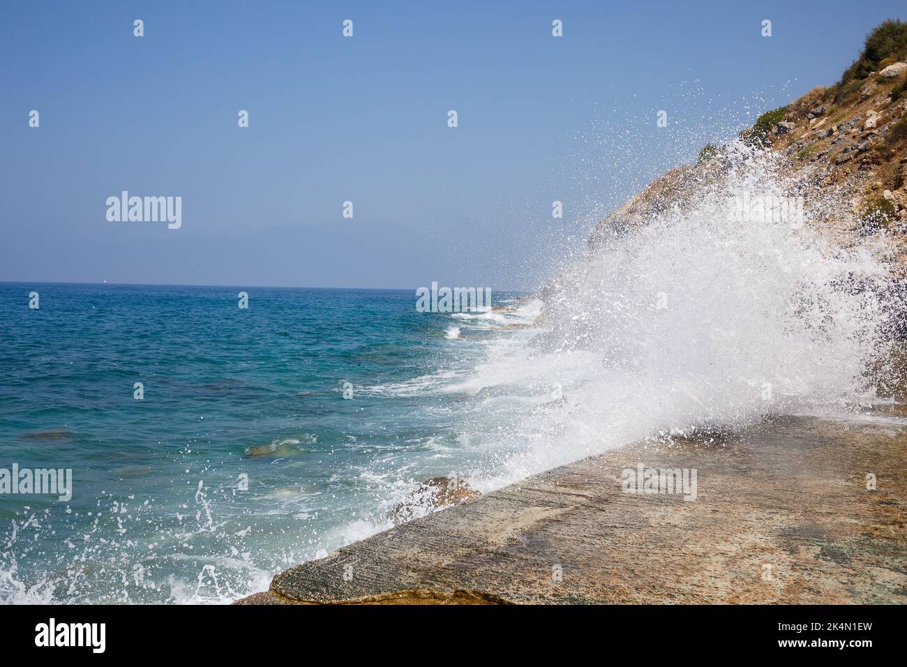 Sea water beats against rocky rocks and makes waves with foam Stock ...