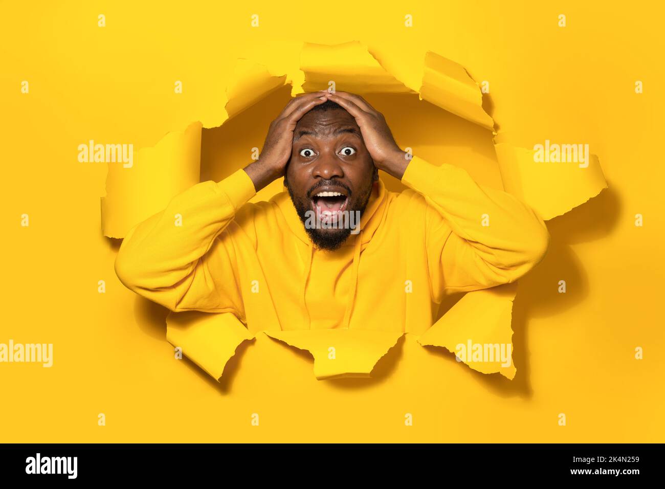 Wow. Portrait of overjoyed black man with open mouth touching head and ...