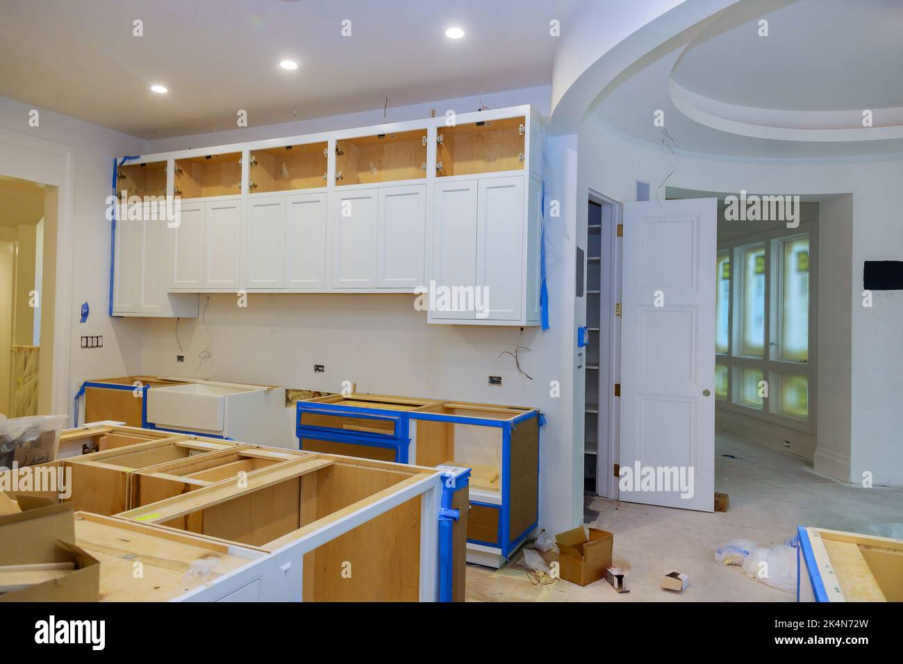 In a newly constructed house, the installation of white cabinets in the ...
