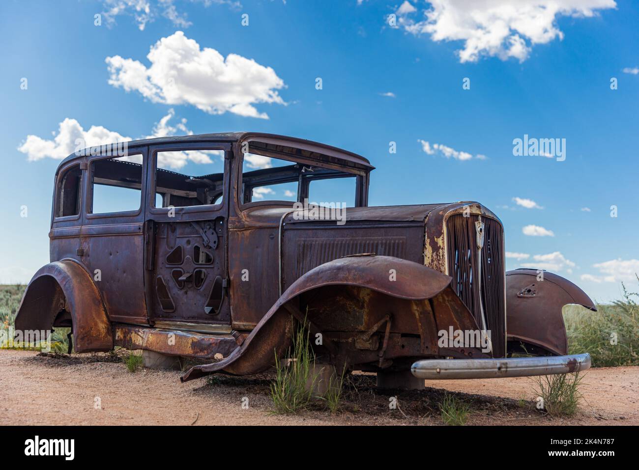 A weathered and rusting Studebaker antique car sitting along the old ...