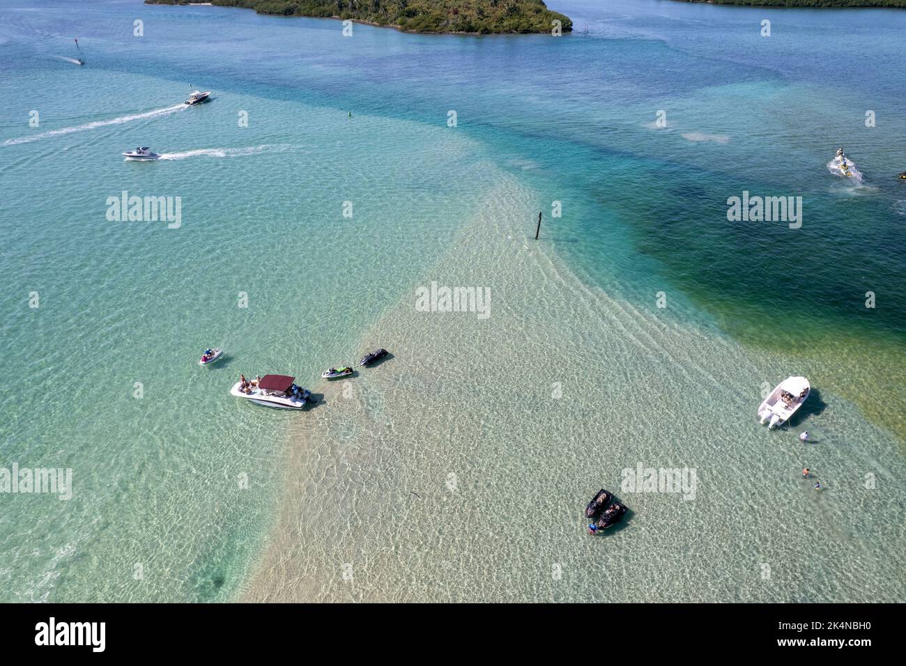 An aerial view of the beautiful Haulover Sandbar in Miami with ships on ...