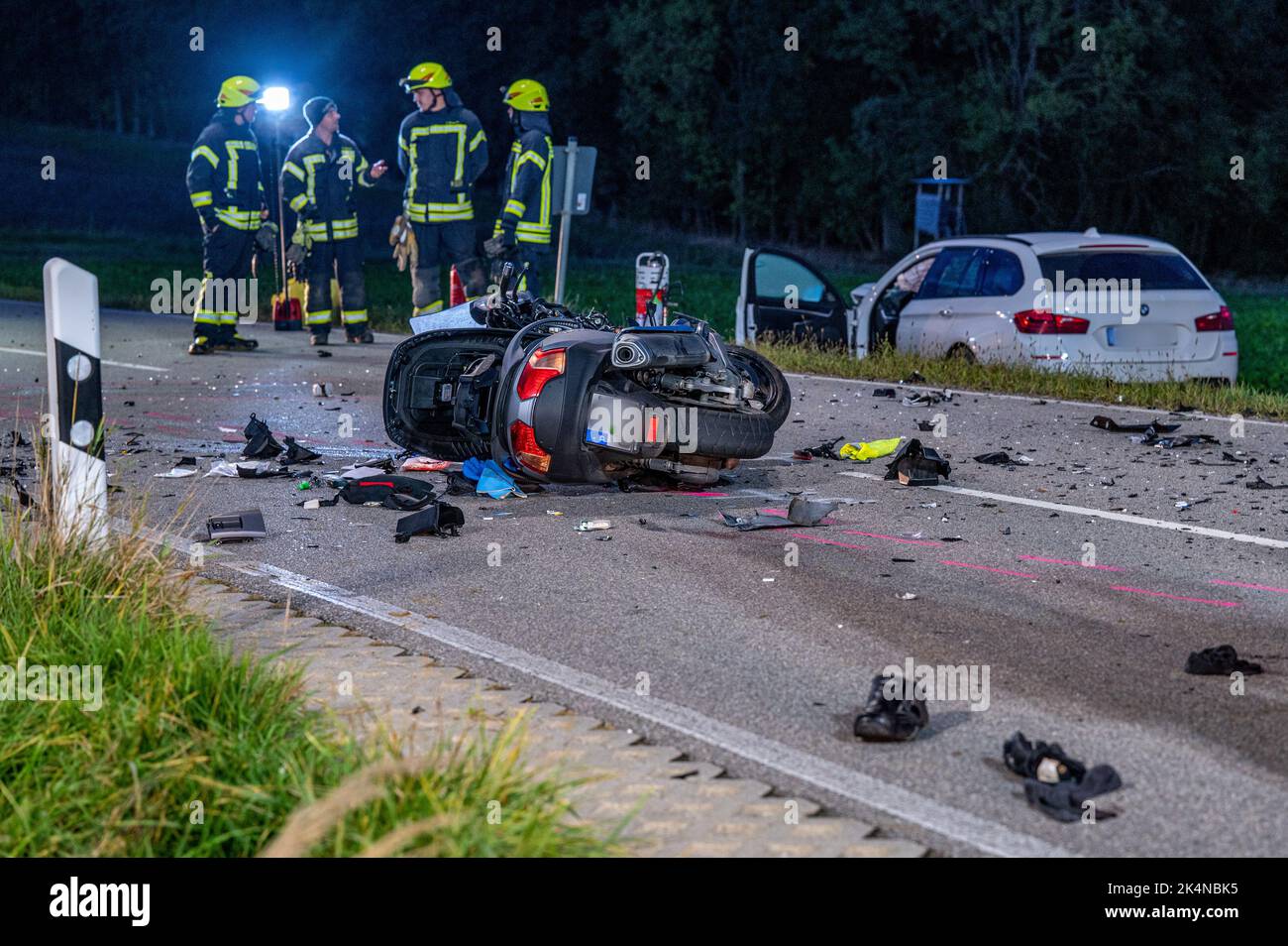 03 October 2022, Bavaria, Geiselhöring: Firefighters stand behind a ...