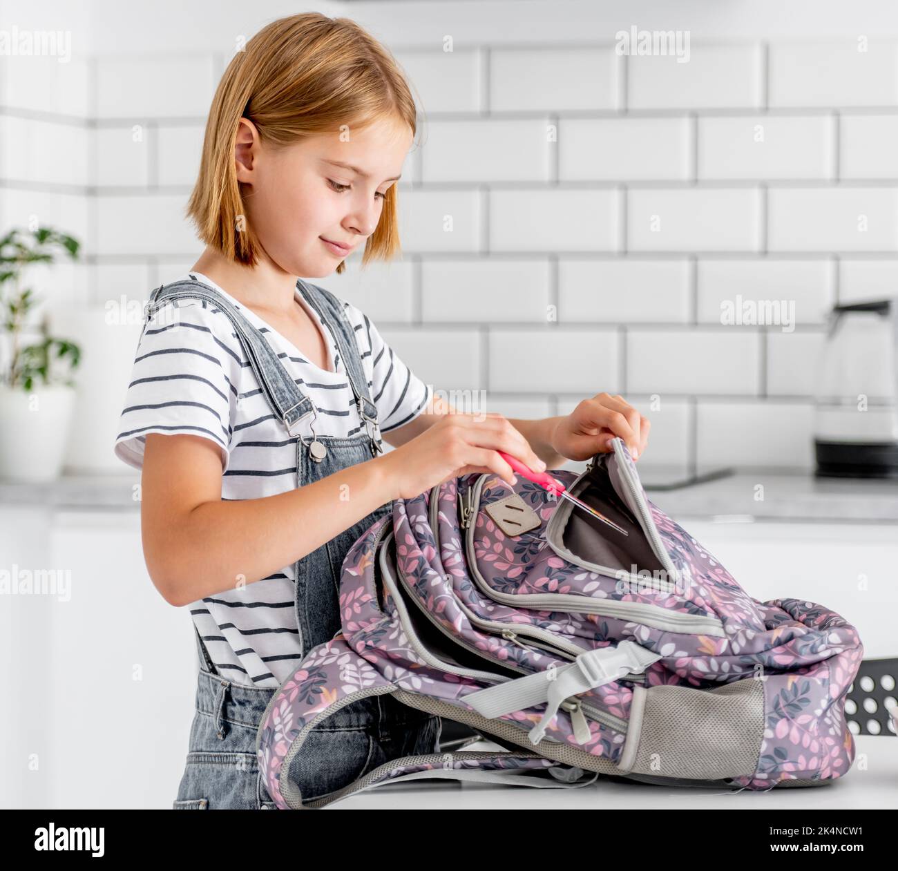 Girl preparing backpack Stock Photo - Alamy