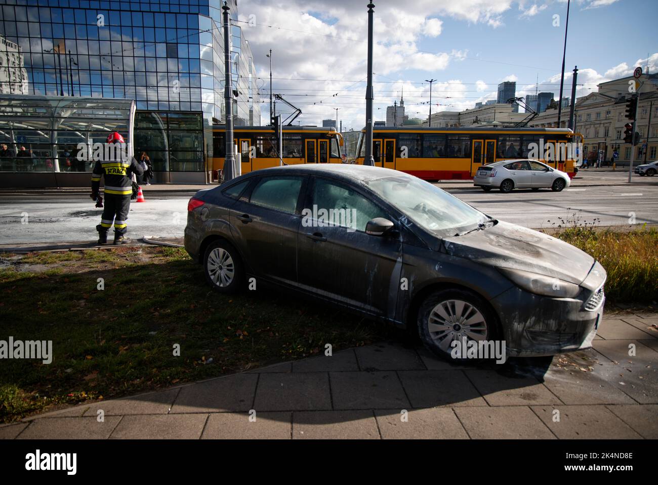 A Ford car is seen covered in powder after a fire from in its engine ...