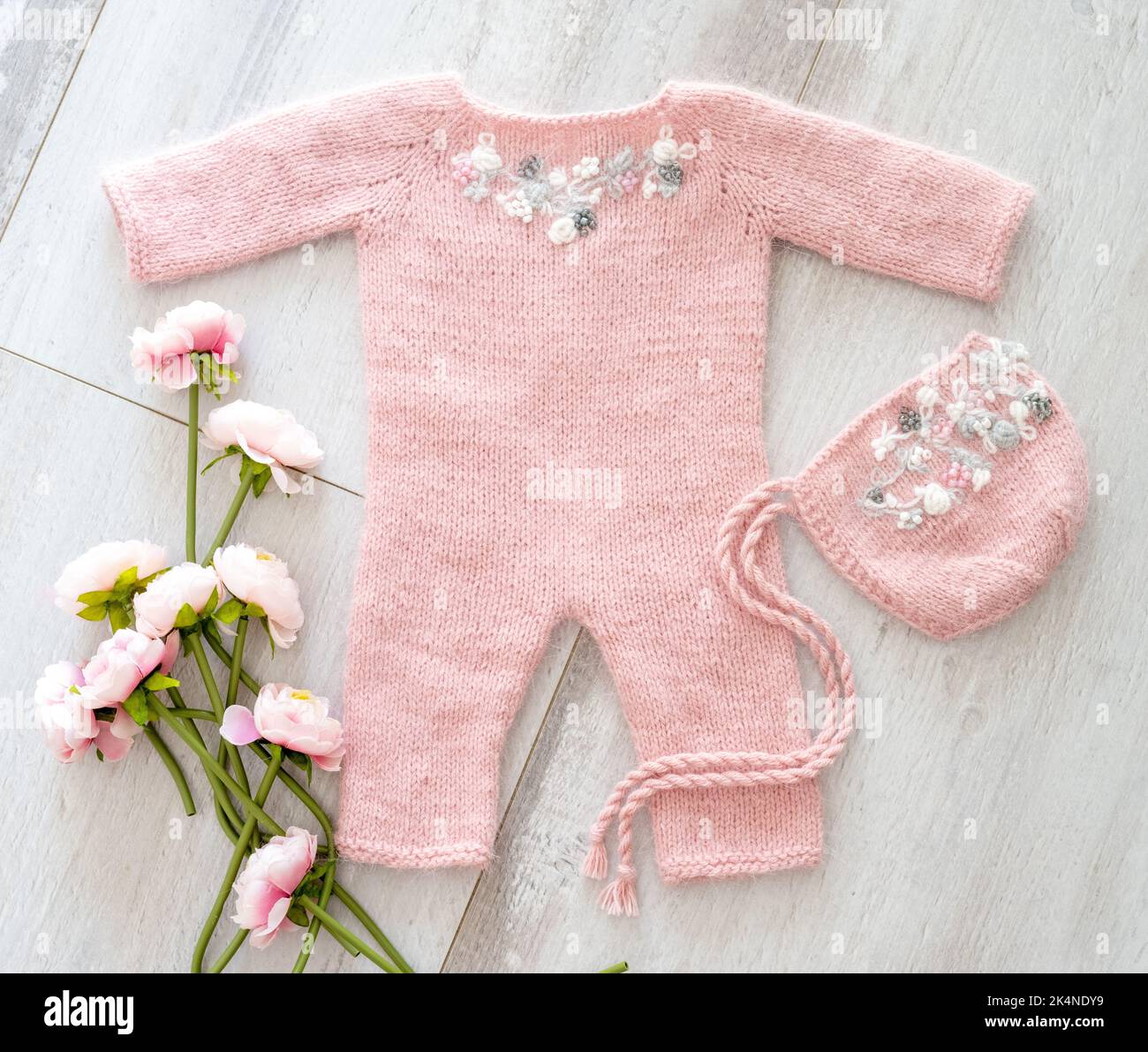 Simple knitted handmade clothes for newborn babies Stock Photo - Alamy