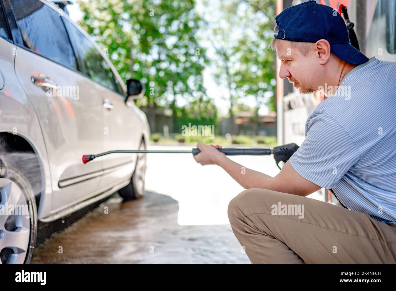 Shot of a man washing his car Stock Photo - Alamy
