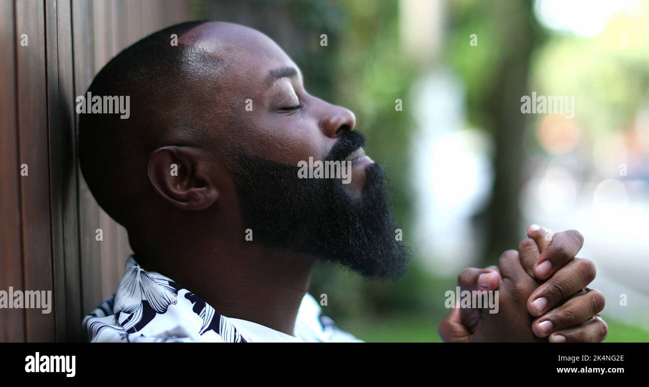 Positive African man feeling spiritual and happy. Hopeful and faithful ...