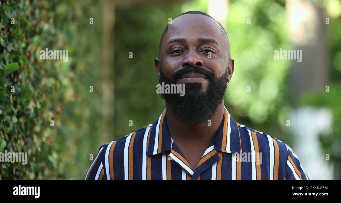 Positive happy African man smiling outside breathing fresh air Stock ...