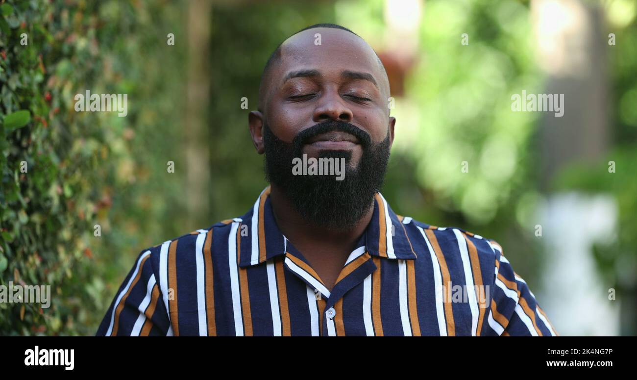 Positive happy African man smiling outside breathing fresh air Stock ...
