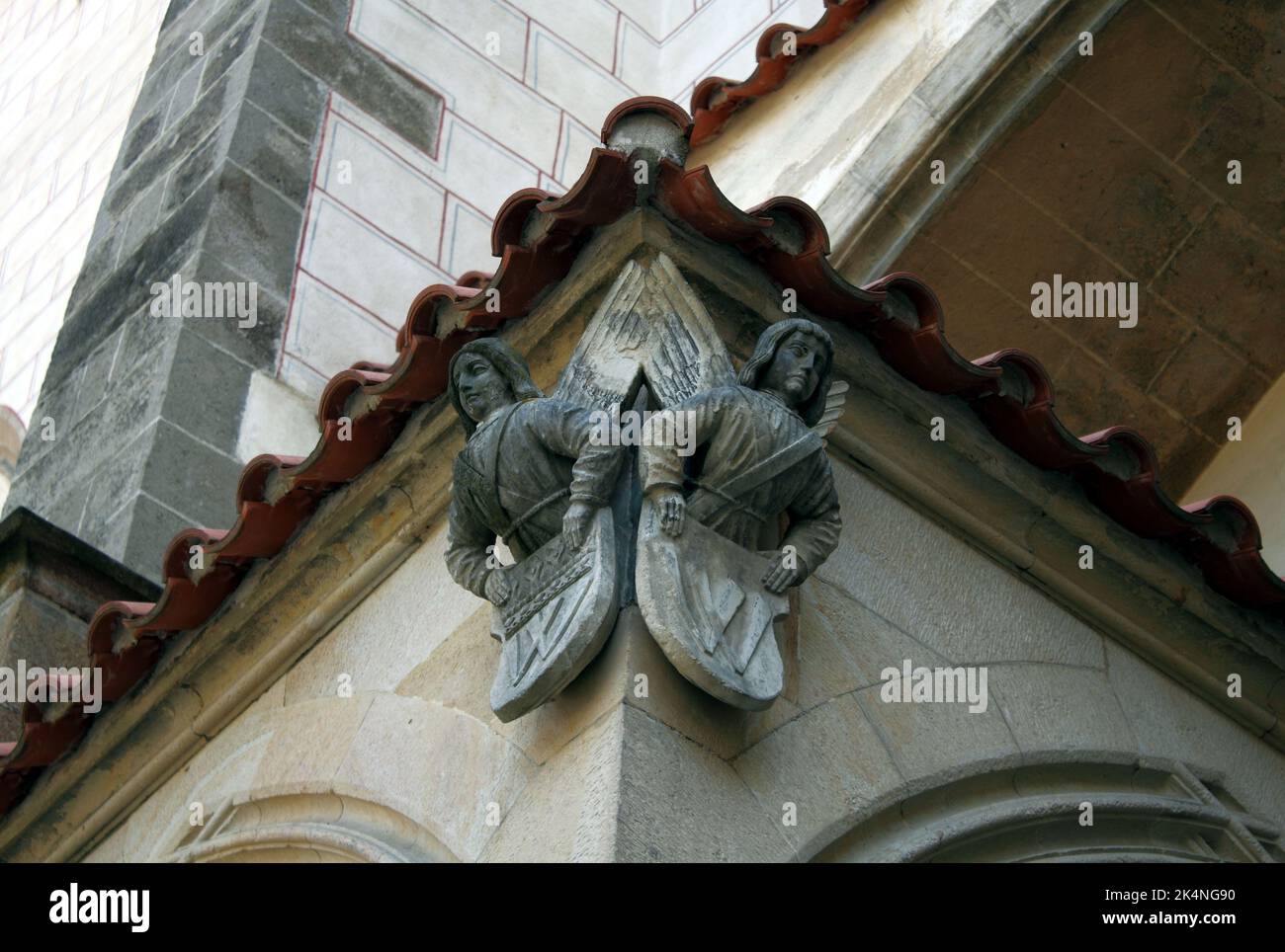 A close-up shot of angel sculptures hanging from the building's corner ...