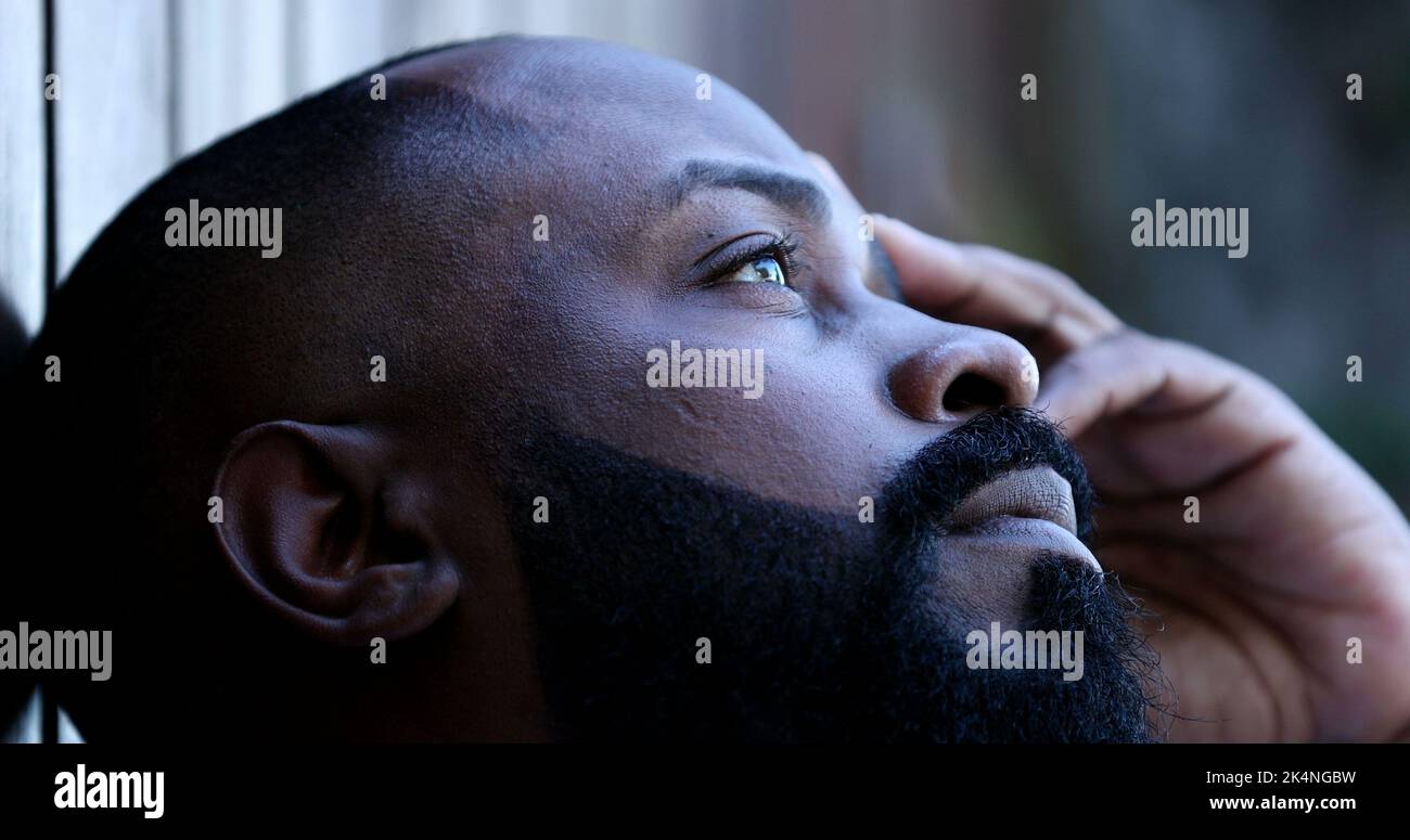 Pensive black man. Contemplative African person looking up close-up ...