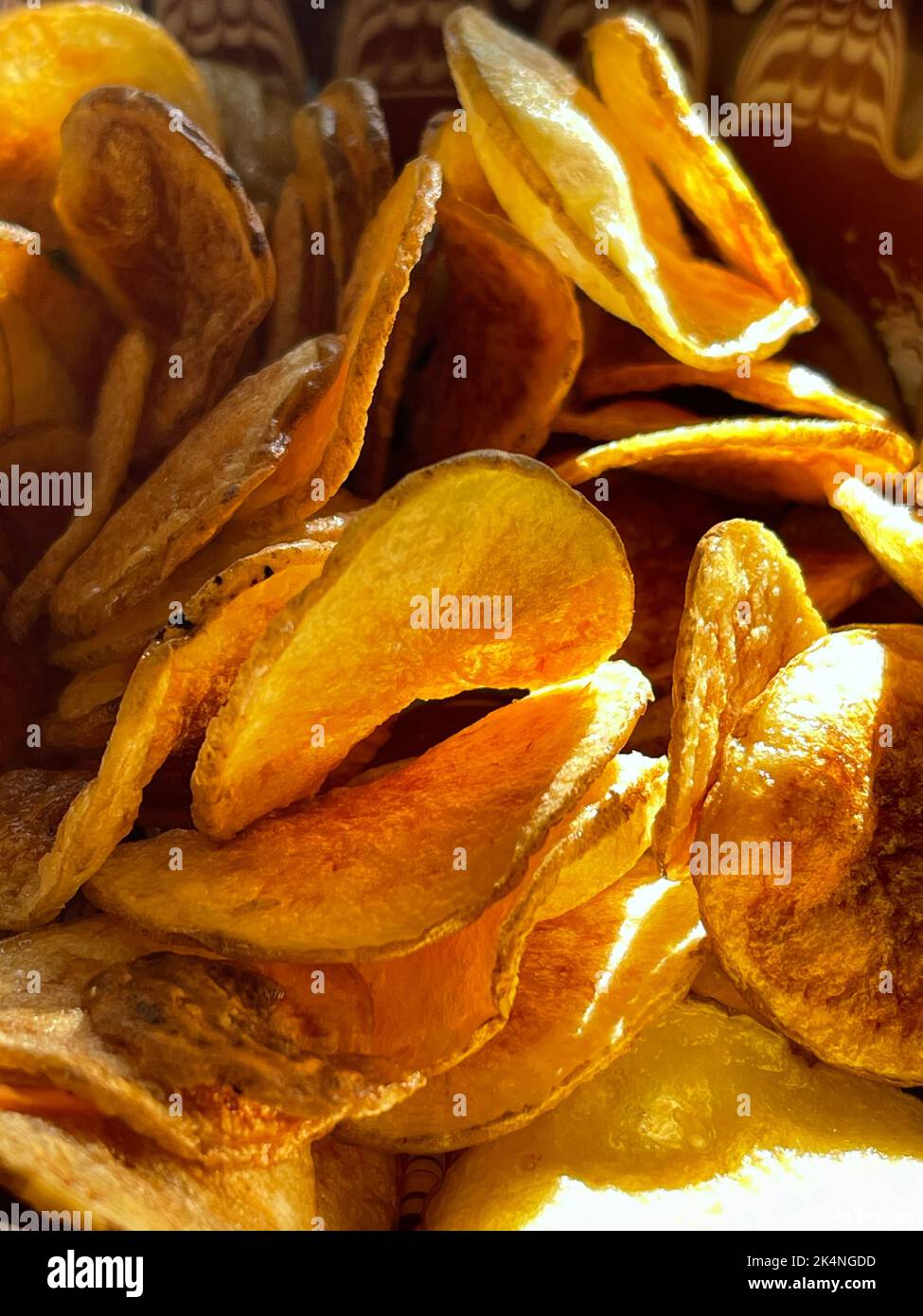 A vertical closeup shot of salty sliced potato chips Stock Photo - Alamy