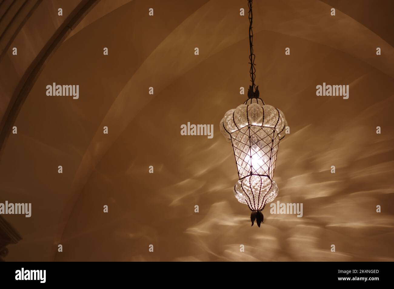 A vintage chandelier hanging from a ceiling Stock Photo - Alamy