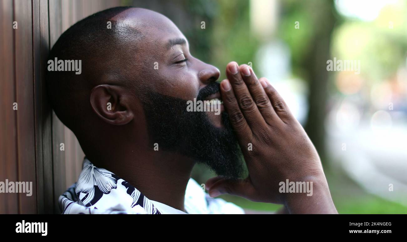 Positive African man feeling spiritual and happy. Hopeful and faithful ...