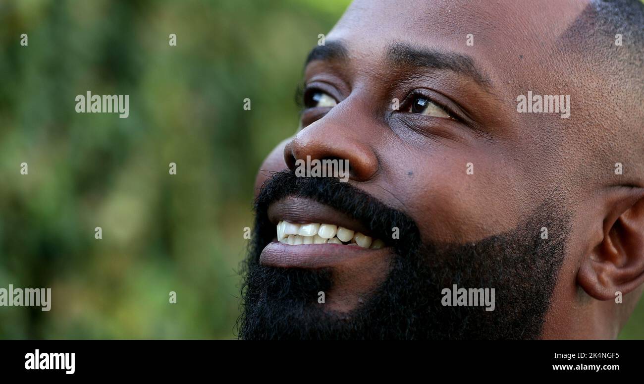 Positive African breathing fresh air outside, happy close-up face ...