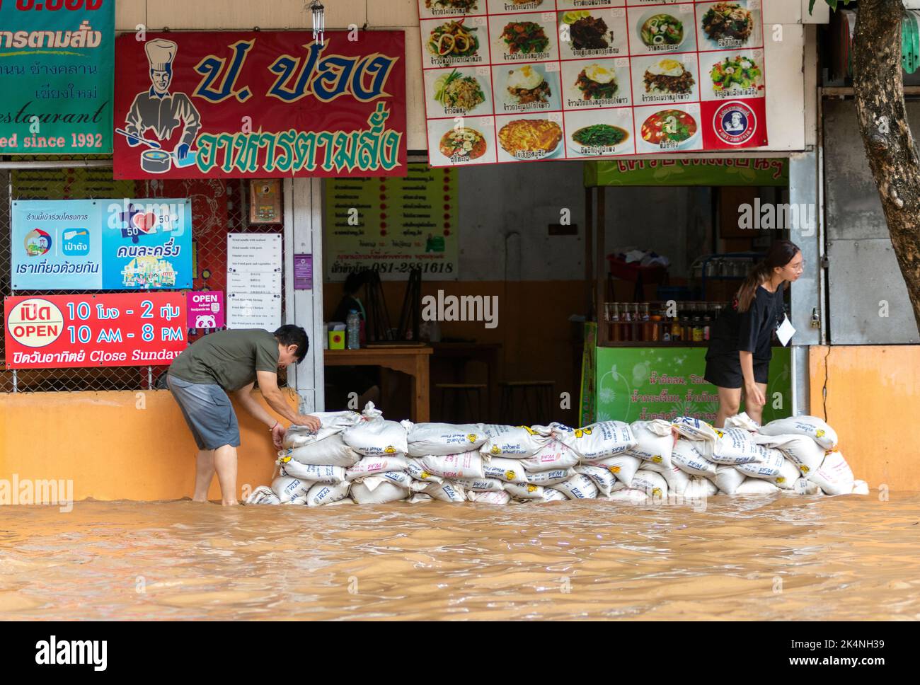 Chiang Mai, Thailand. 03rd Oct, 2022. A man makes a water barrier ...