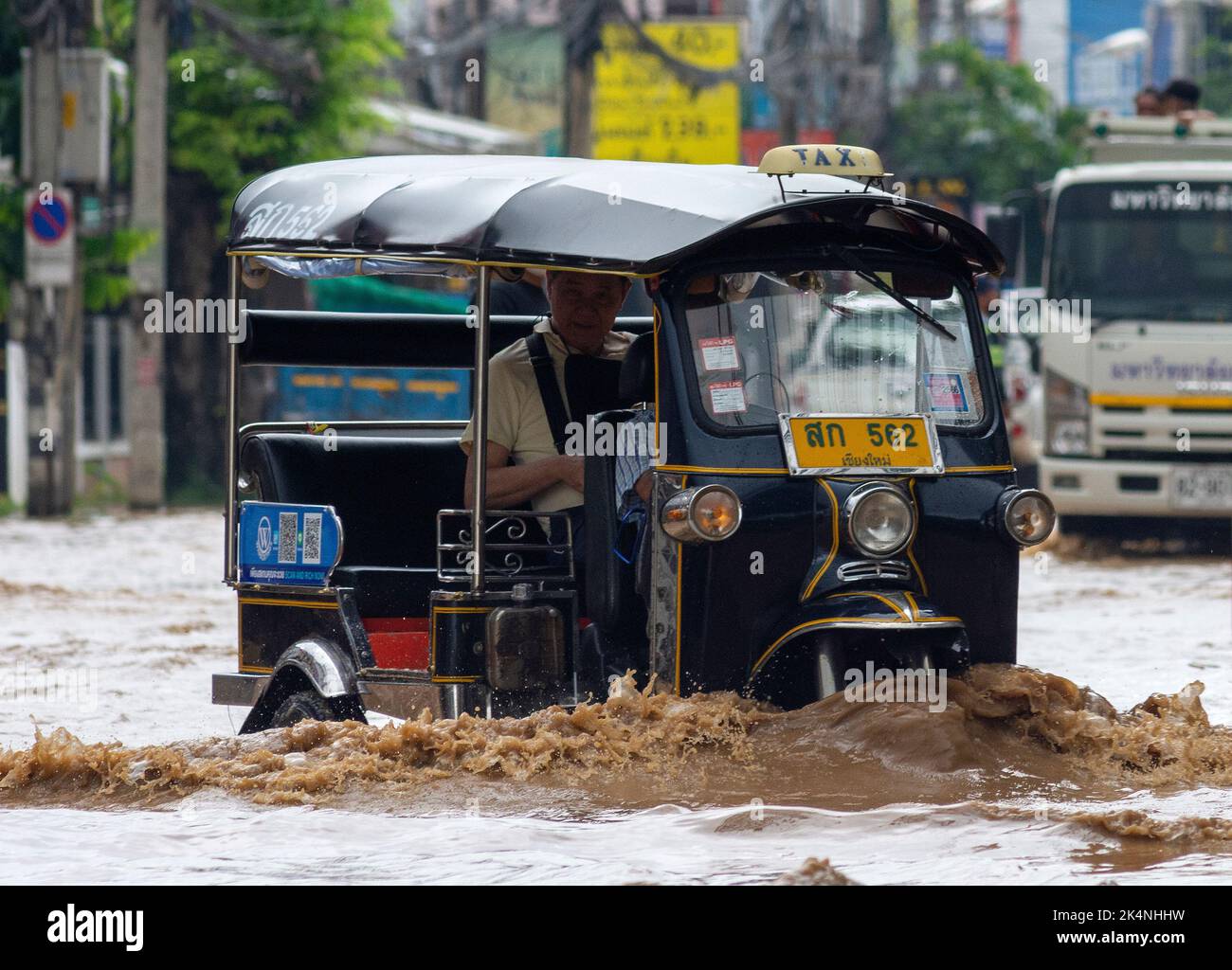 Chiang Mai, Thailand. 03rd Oct, 2022. A taxi driver wades through ...