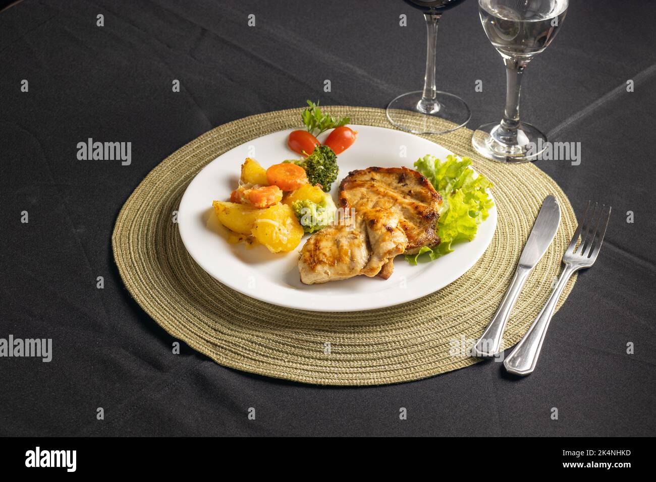 A close-up shot of a chicken fillet with vegetables on a plate Stock ...
