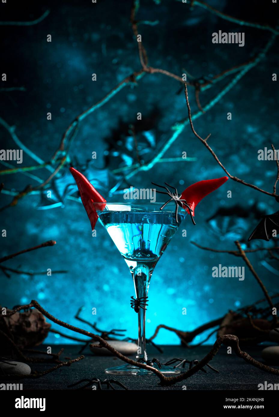 Halloween alcoholic cocktail evil martini on scary dark blue background ...