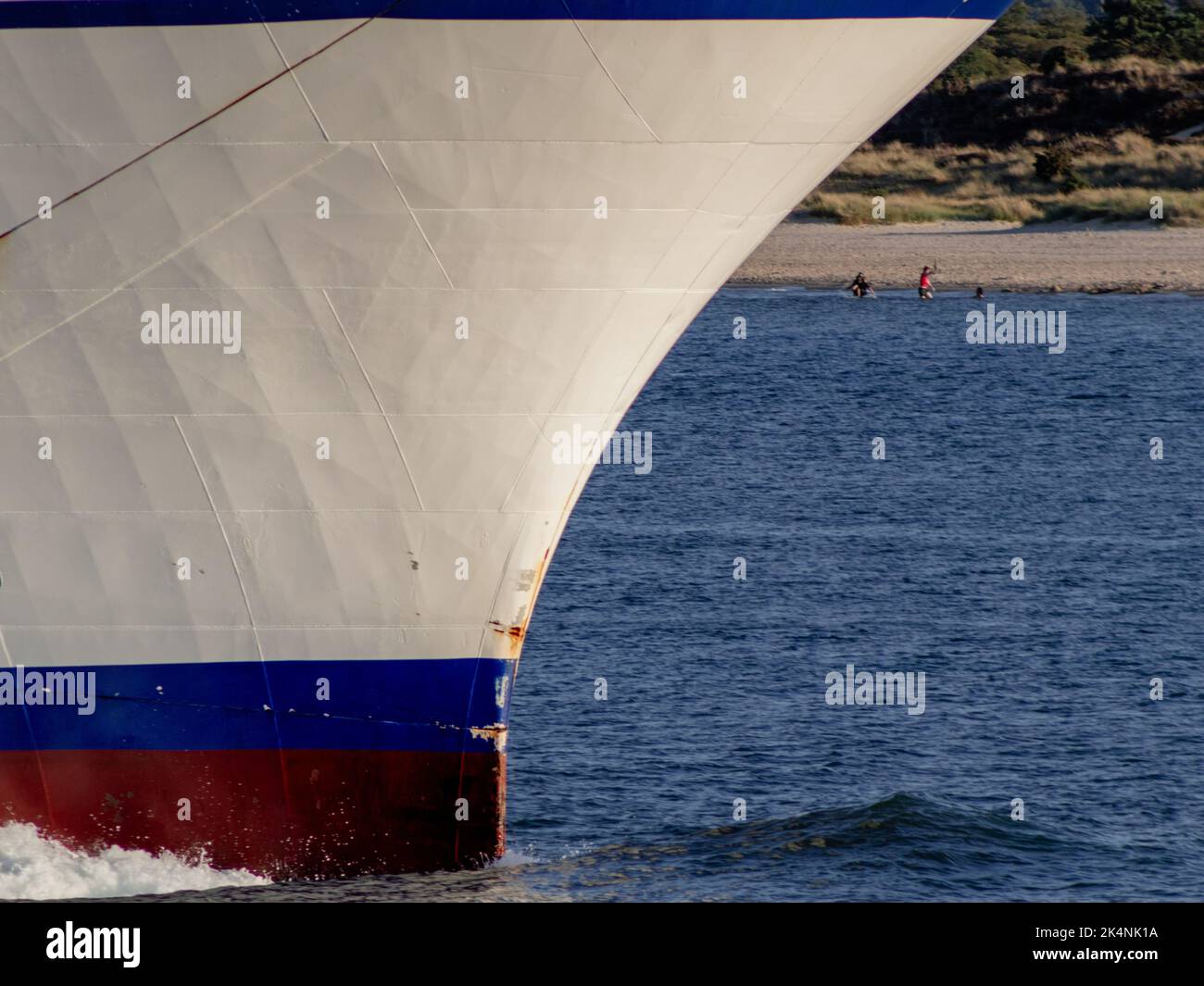 A Ferry Passing People Swimming Stock Photo - Alamy