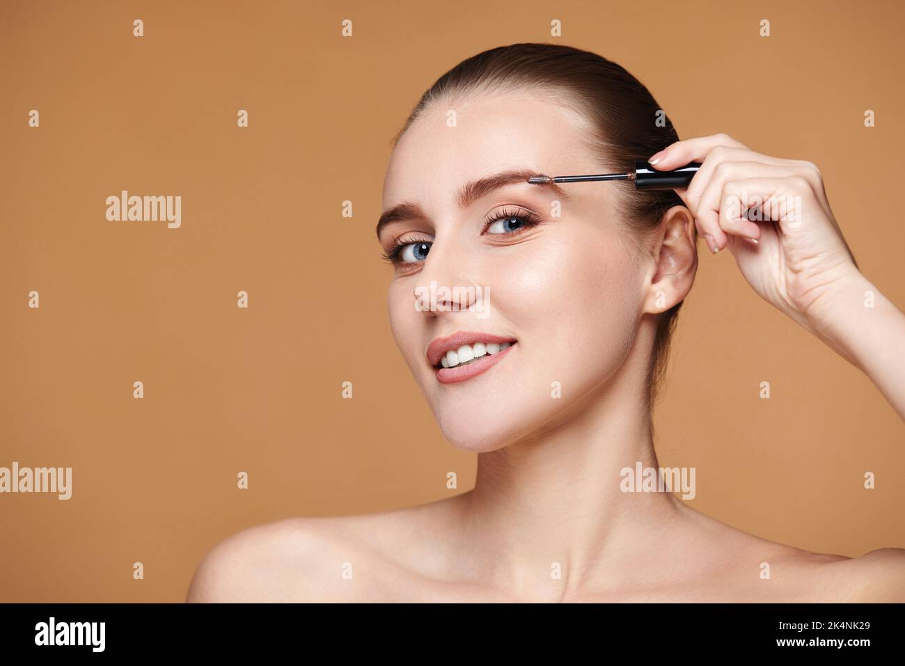 woman with perfect shape eyebrows on beige background Stock Photo - Alamy